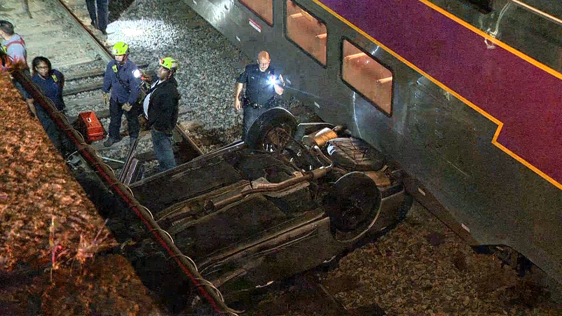 Car falls onto commuter rail tracks after crash in Boston | ABC6