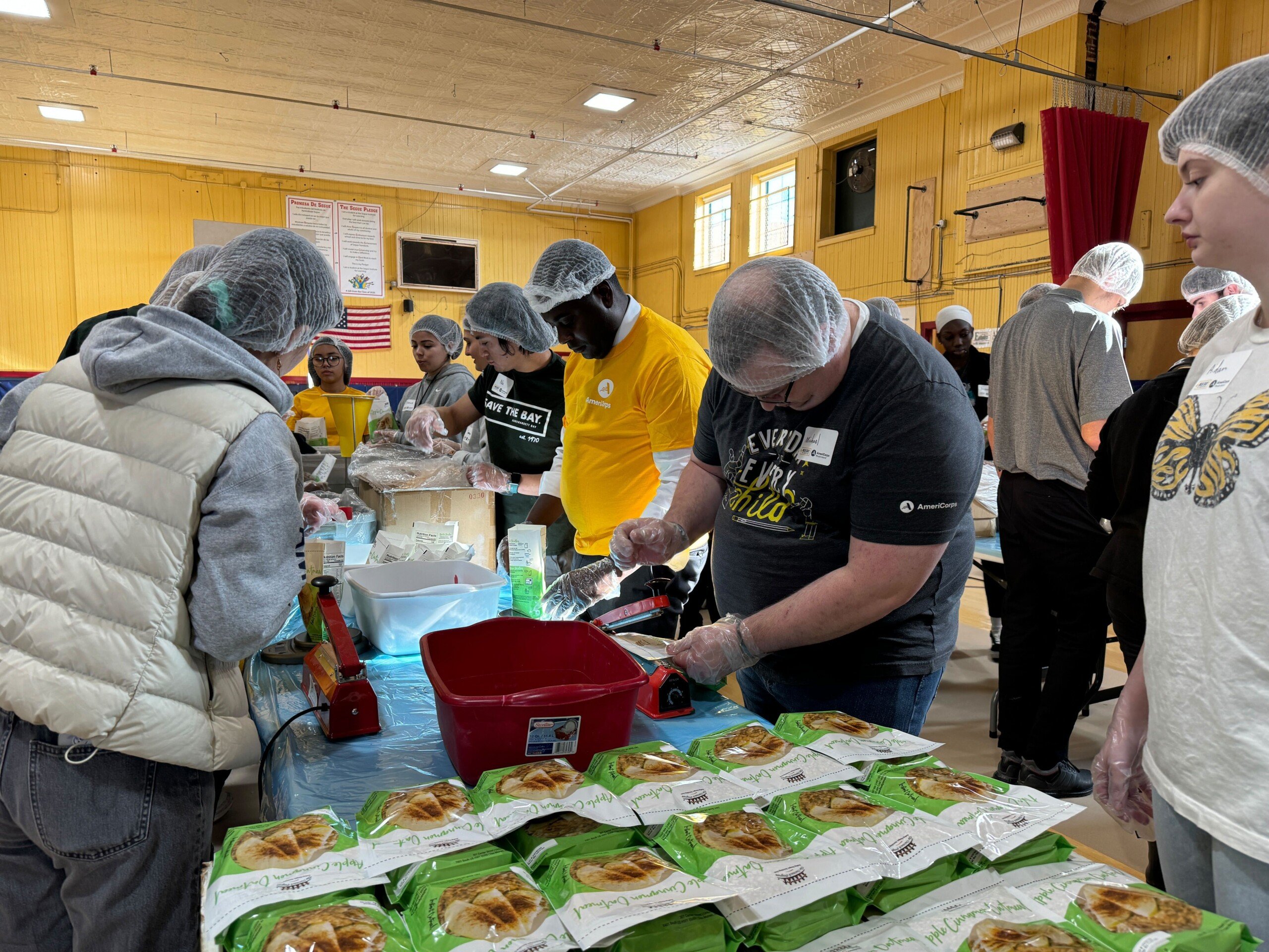 Volunteers help put together thousands of meals in honor of Martin ...