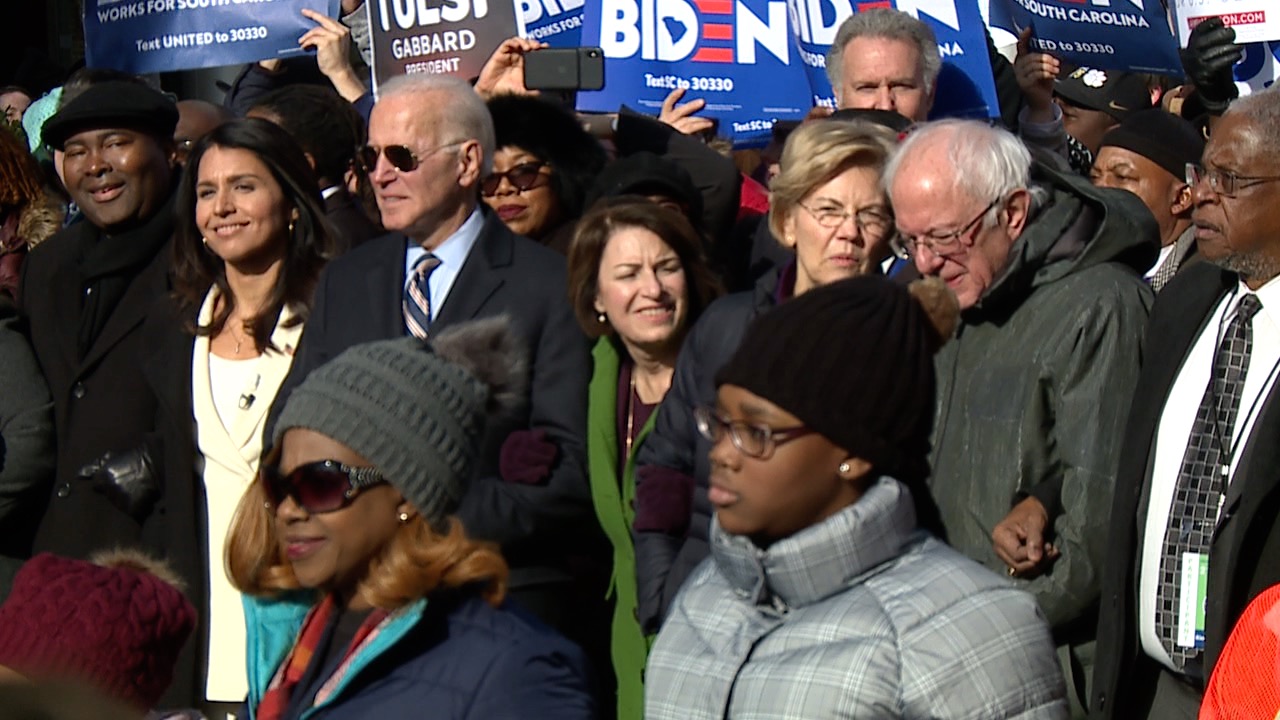 Democratic presidential candidates link arms, march together to honor ...