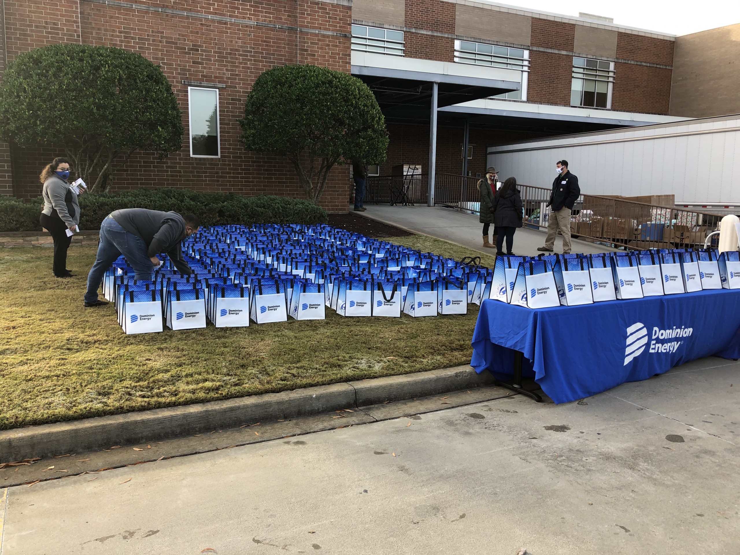 Dominion Energy employees hand out hundreds of food baskets to needy ...
