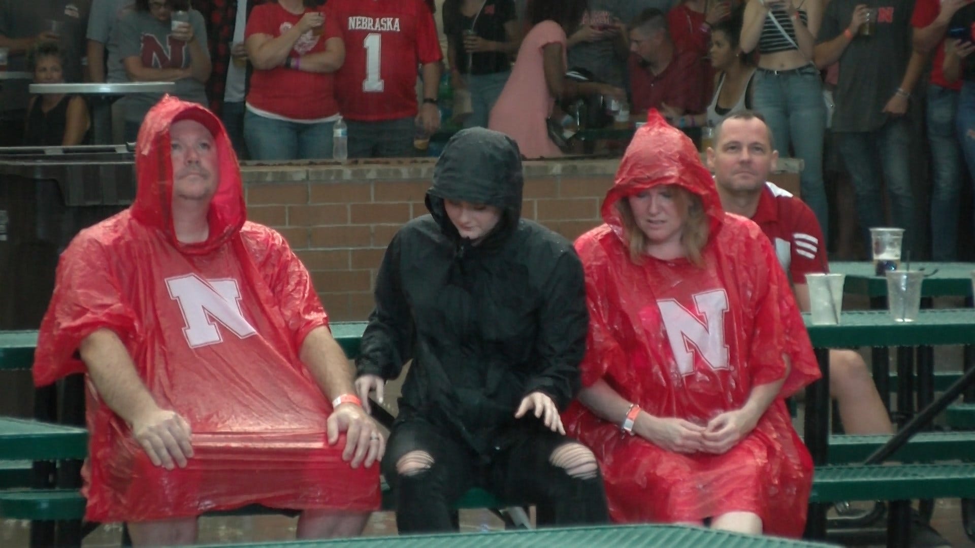 Husker fans brave the rain to cheer on the Cornhuskers as they p