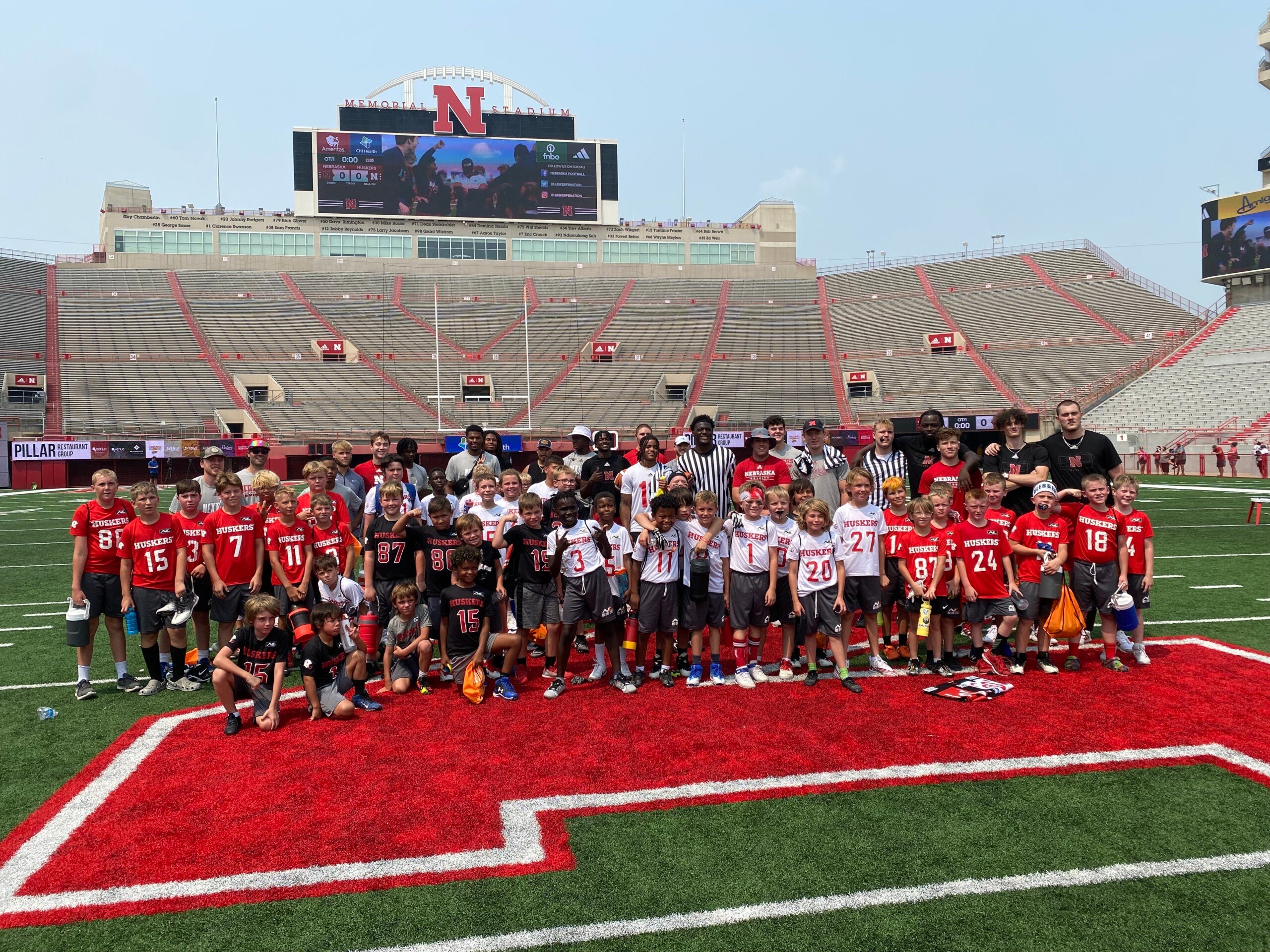 Husker players help coach youth football camp at Memorial Stadium