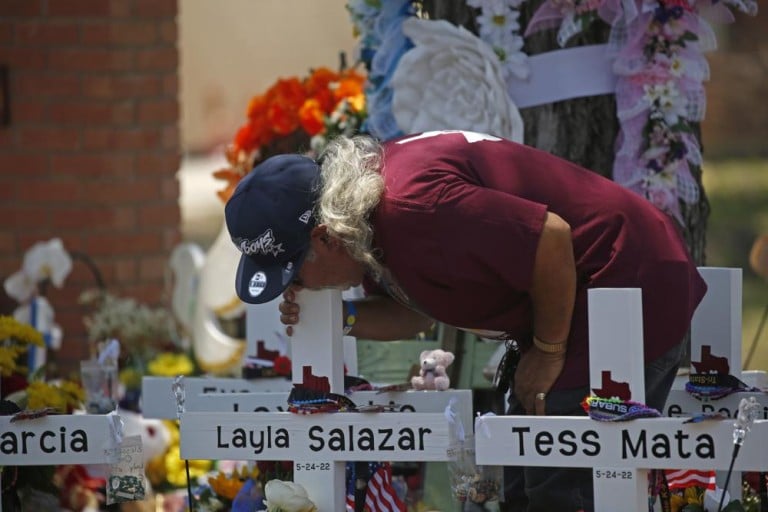 A man kisses the cross of Layla Salazar at a memorial outside Robb ...