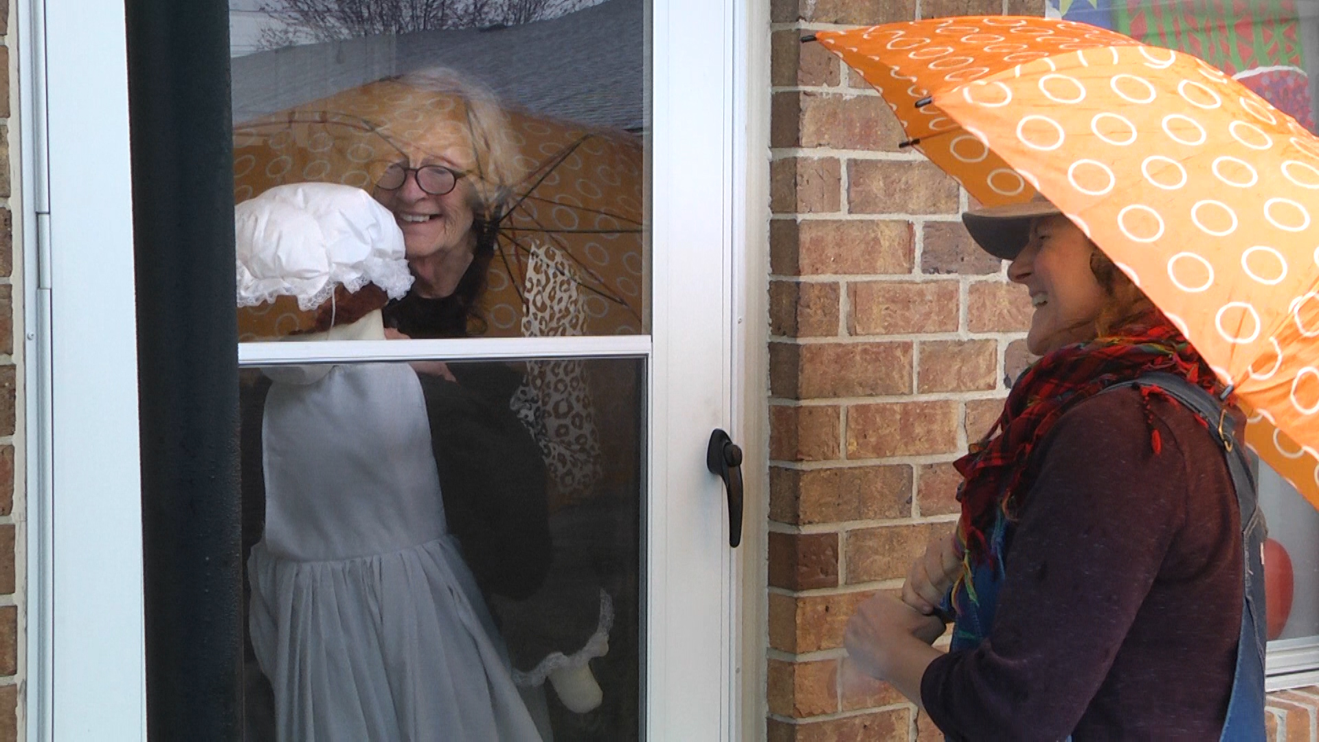Daughter visits her mother through the window of a senior living ...