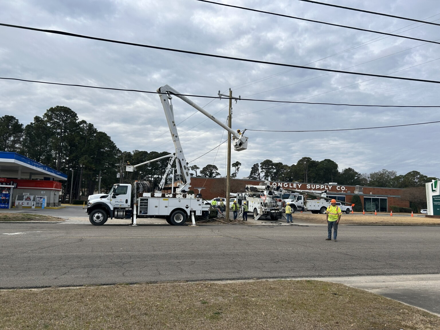 Road closed, driver charged with DWI after truck crashes into utility ...