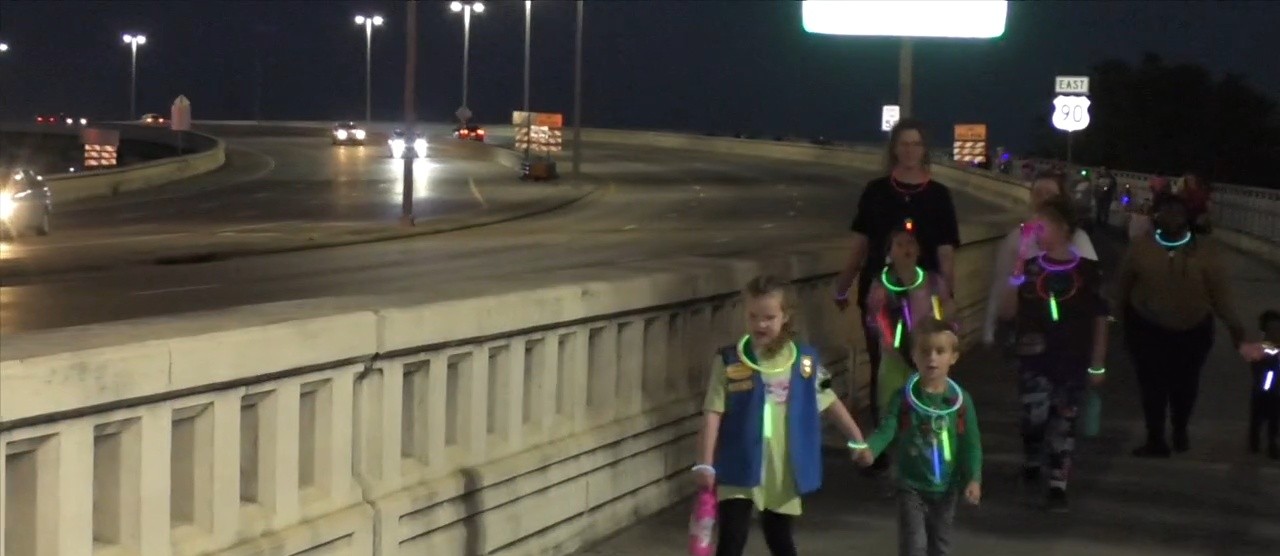 Girl Scouts illuminating Biloxi Ocean Springs Bridge for annual Glow Walk